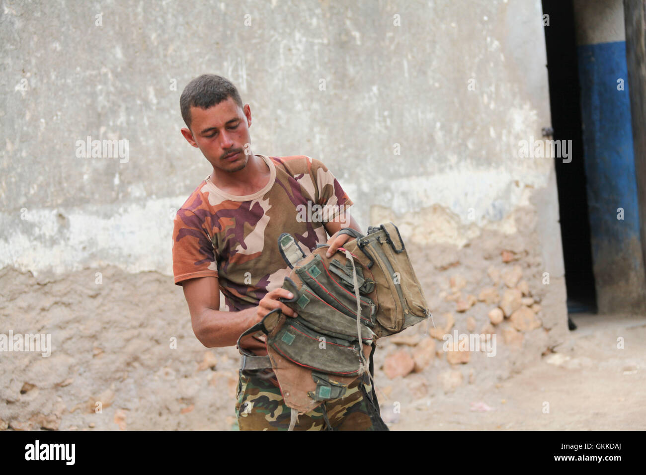 A Djiboutian soldier looks at a bagazine belt left behind after the ...