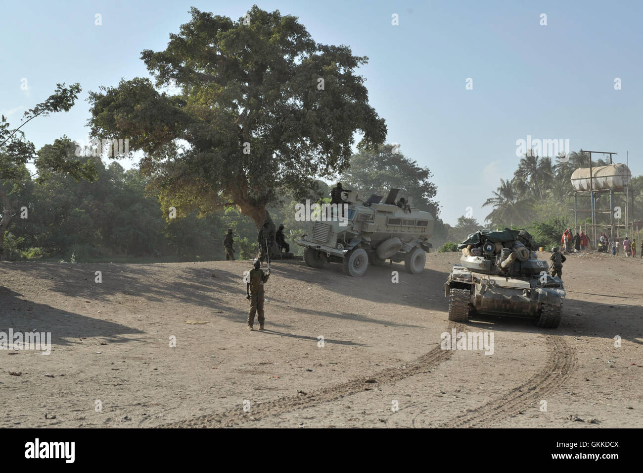 A Ugandan soldier from AMISOM guides a tank through Janaale, Somalia ...