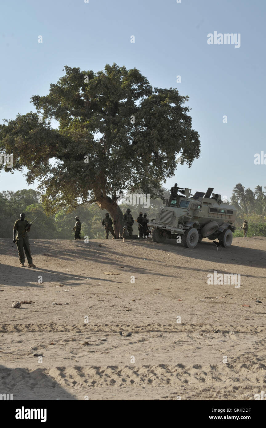 Ugandan soldiers with AMISOM stand by an armored vehicle in Janaale ...