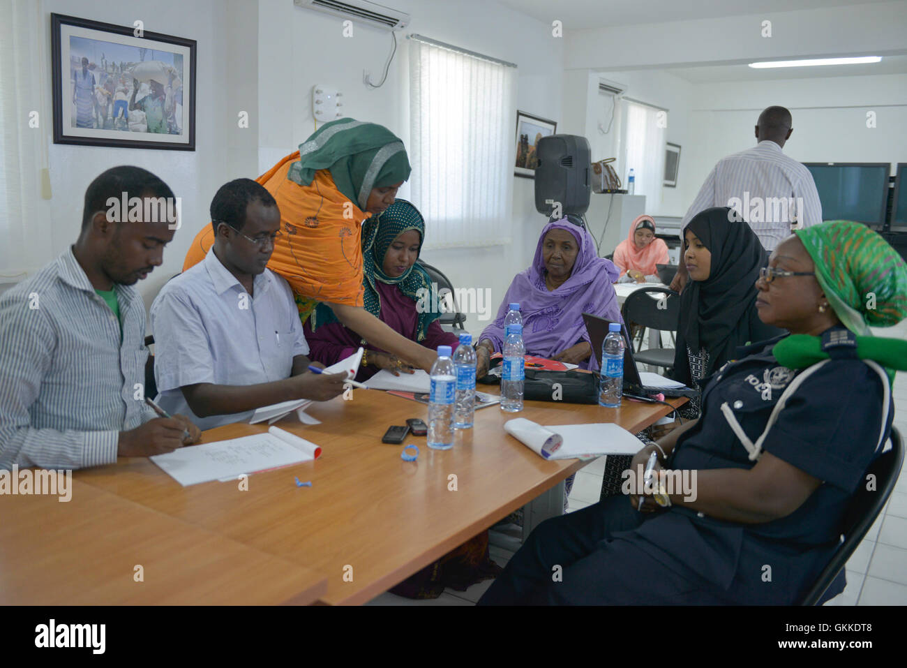 Attendees engage in the review of the Somalia Ministry of Gender ...