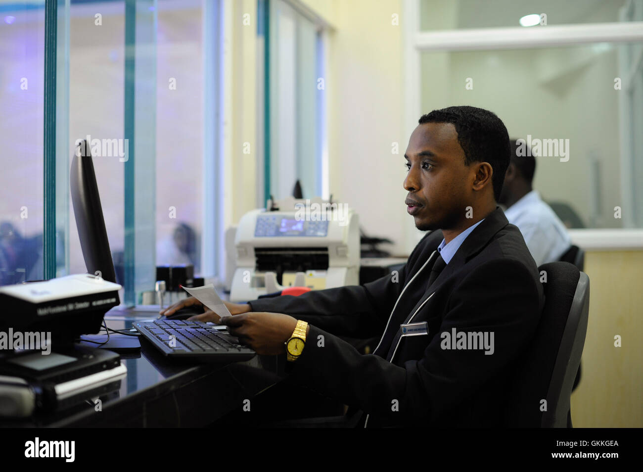 A teller at IBS fulfills a customer’s request. IBS operates under ...