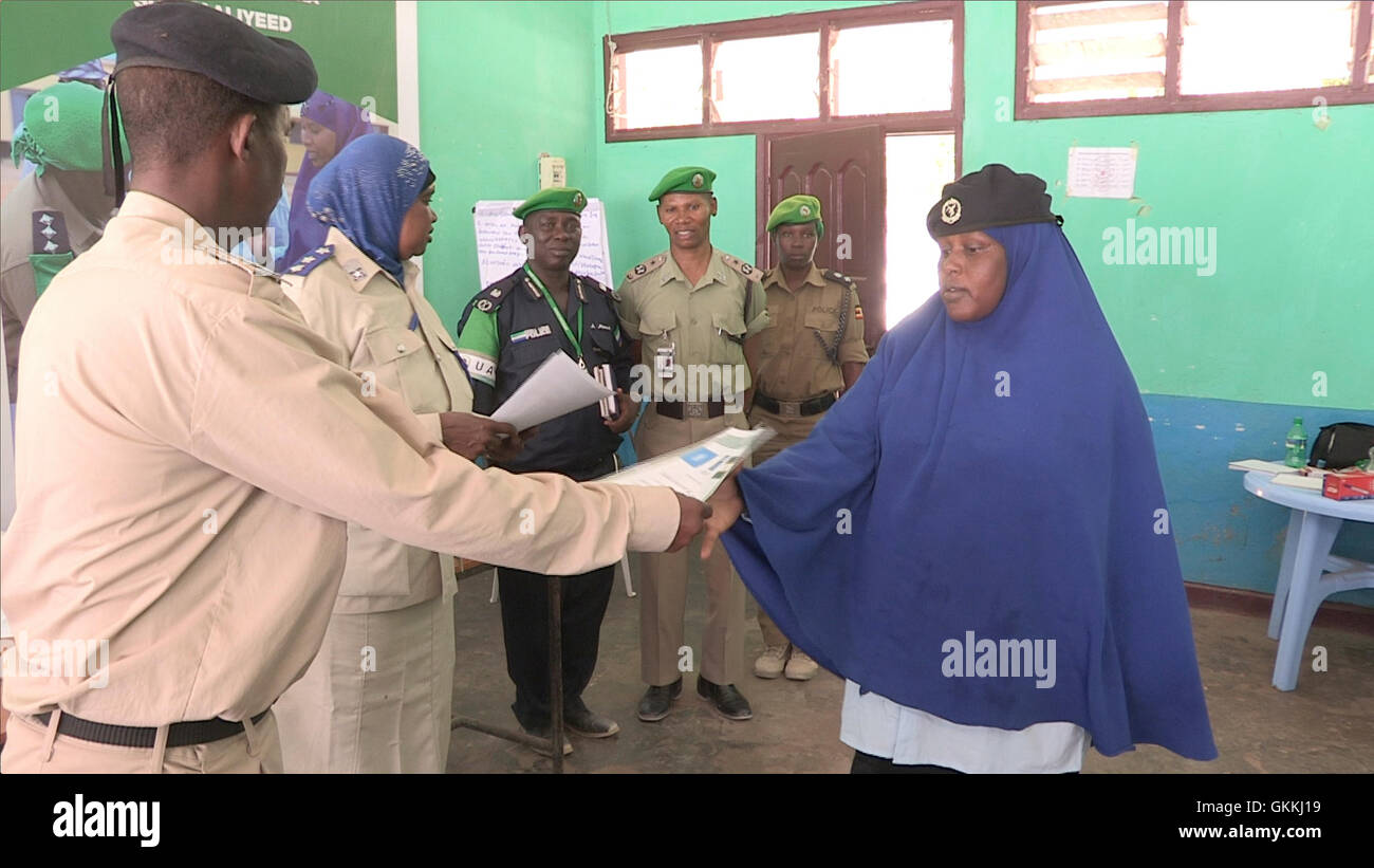 A Somali Police Officer receives a certificate from Col. Mosa Ahmed ...