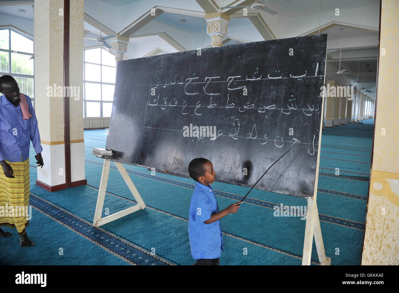 Somali children take lessons on the Quran at a Madrasa in Isbahaysiga ...