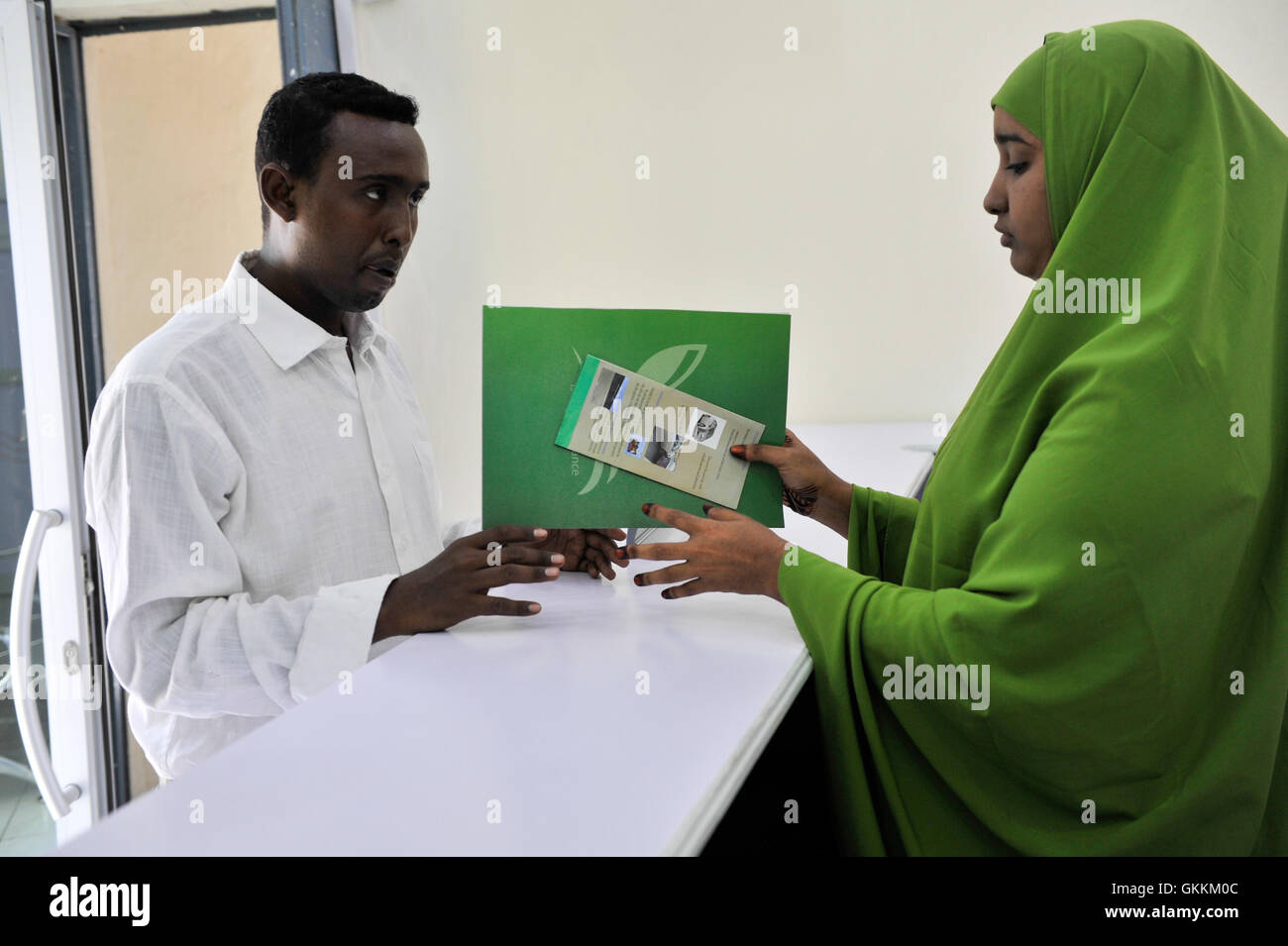 A receptionist assists a client at 'Takaful & Retakaful,' Somalia’s ...