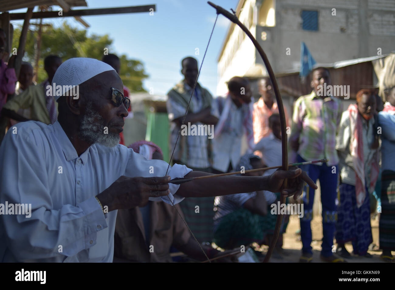 On September 18, a man prepares his bow and arrow for an archery ...