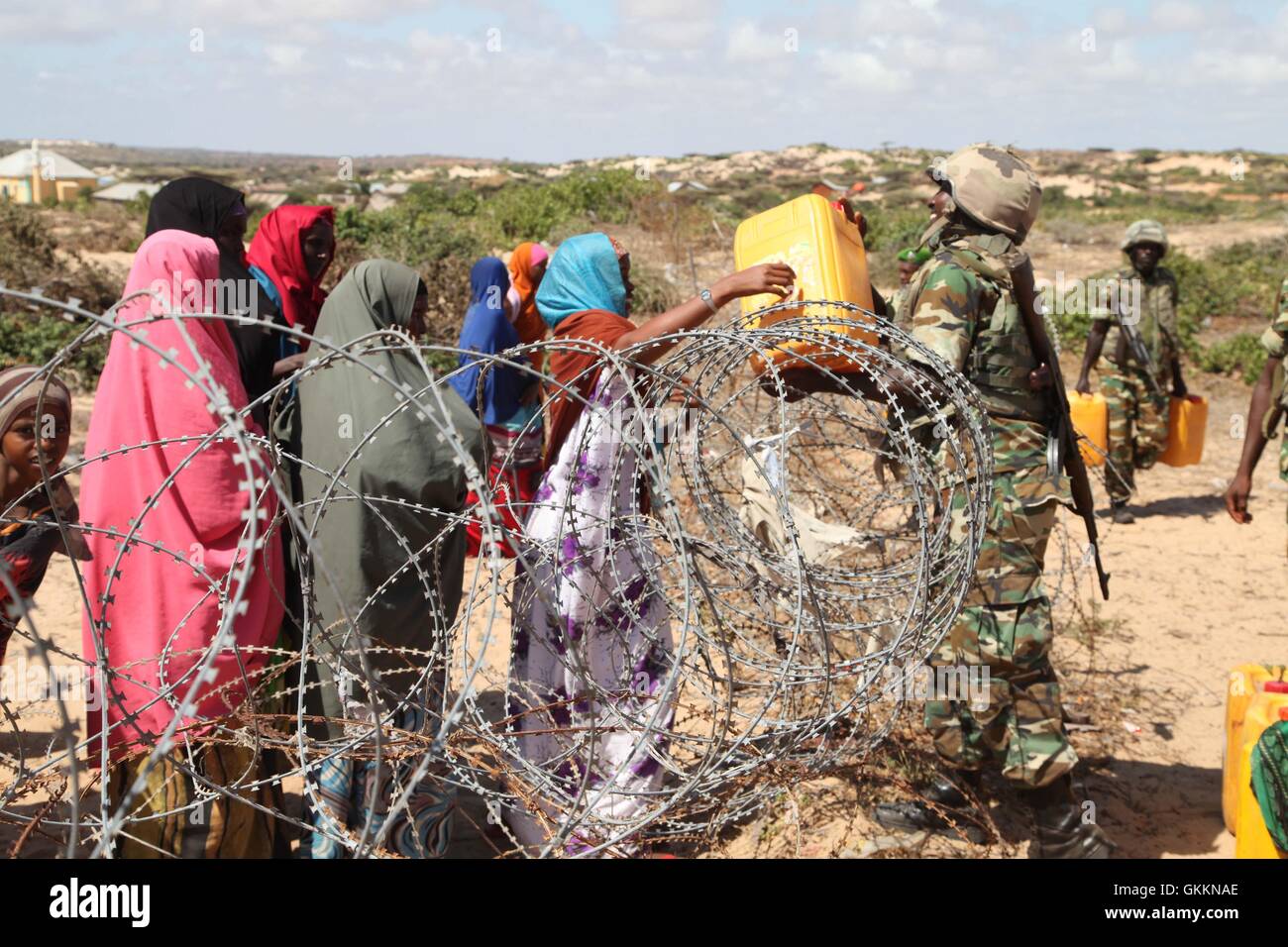 Burundian AMISOM troops distribute clean drinking water to residents of ...