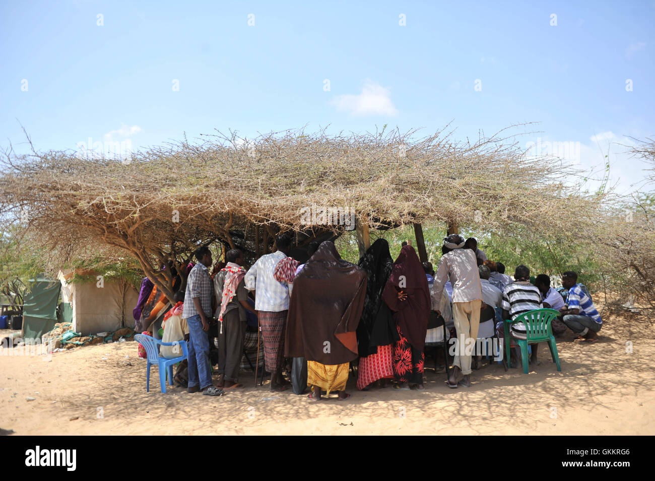 Somali women and elders meet under a tree with an African Union ...