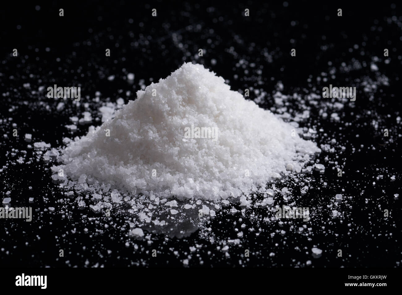 Heap of coarse salt on black background Stock Photo - Alamy