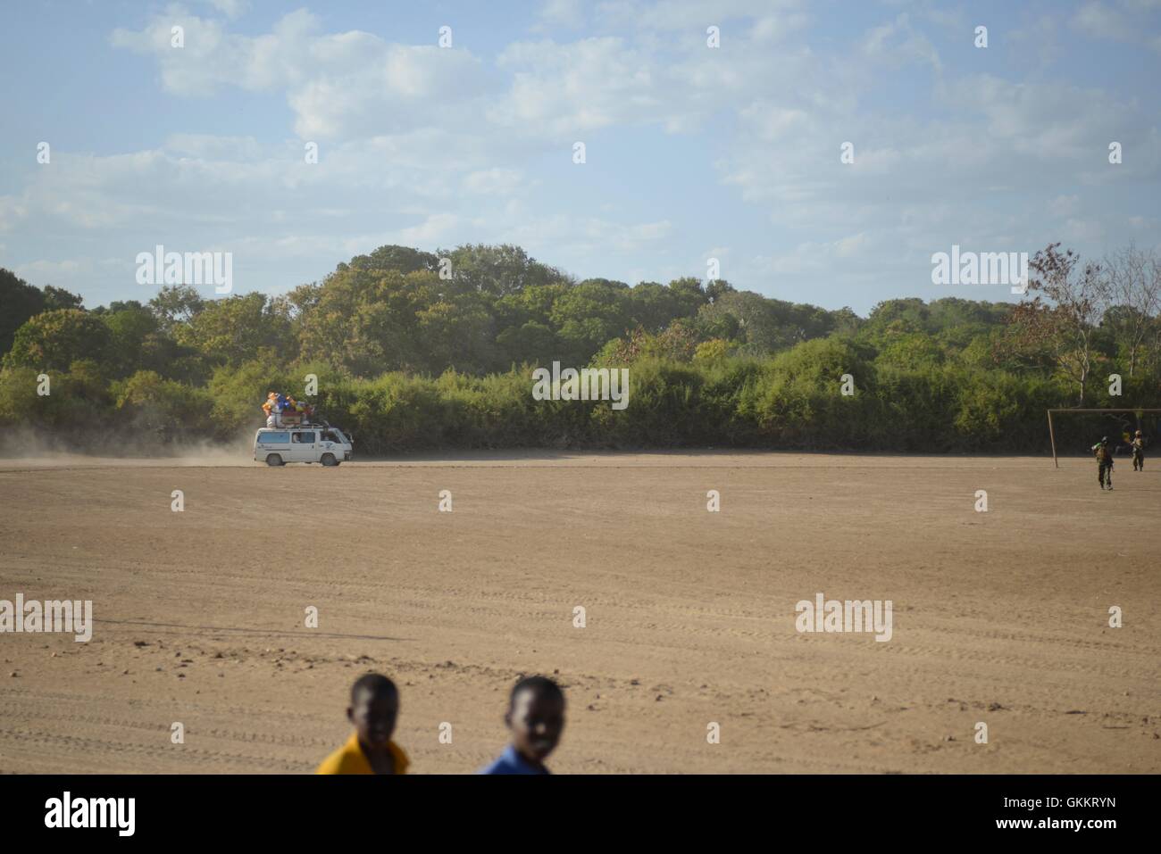 On March 3, a minivan carrying supplies crosses a football pitch en ...