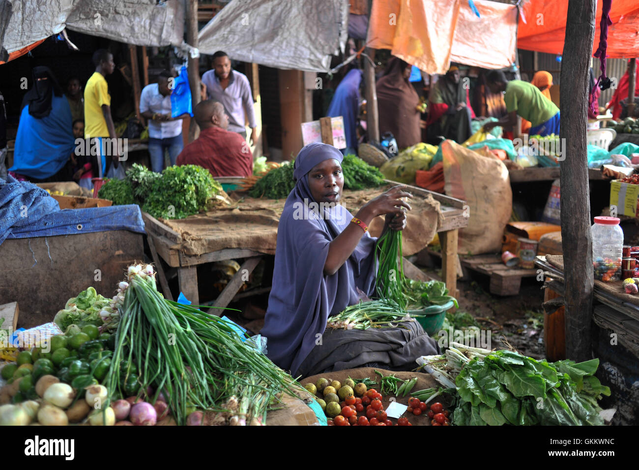 A woman sells vegetables at Hamarwayne Market in Mogadishu, Somalia, on ...