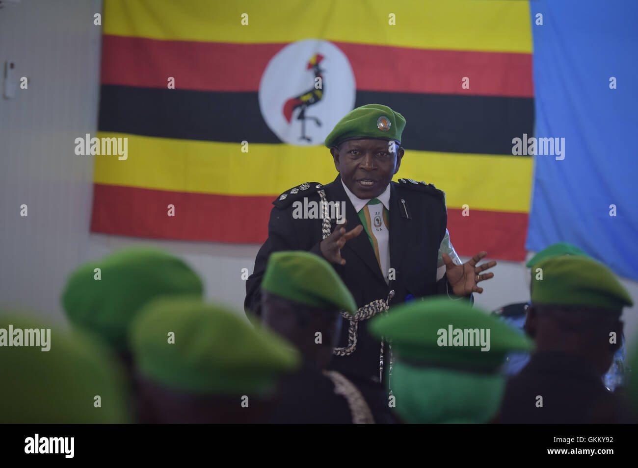 AMISOM police officers listen to a speech at a ceremony thanking them ...