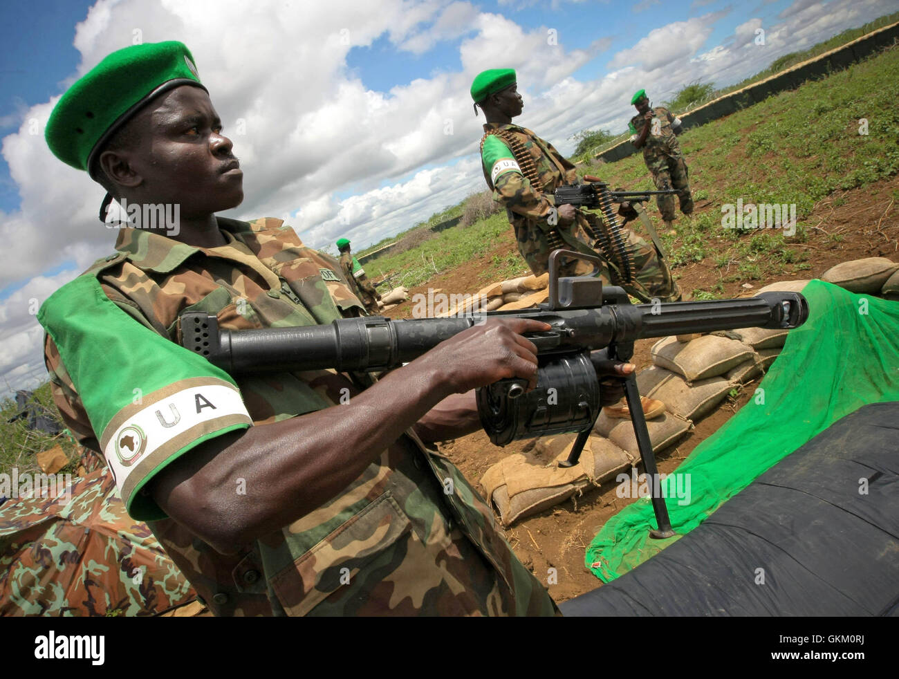 Ugandan soldiers serving with AMISOM hold defensive positions around ...