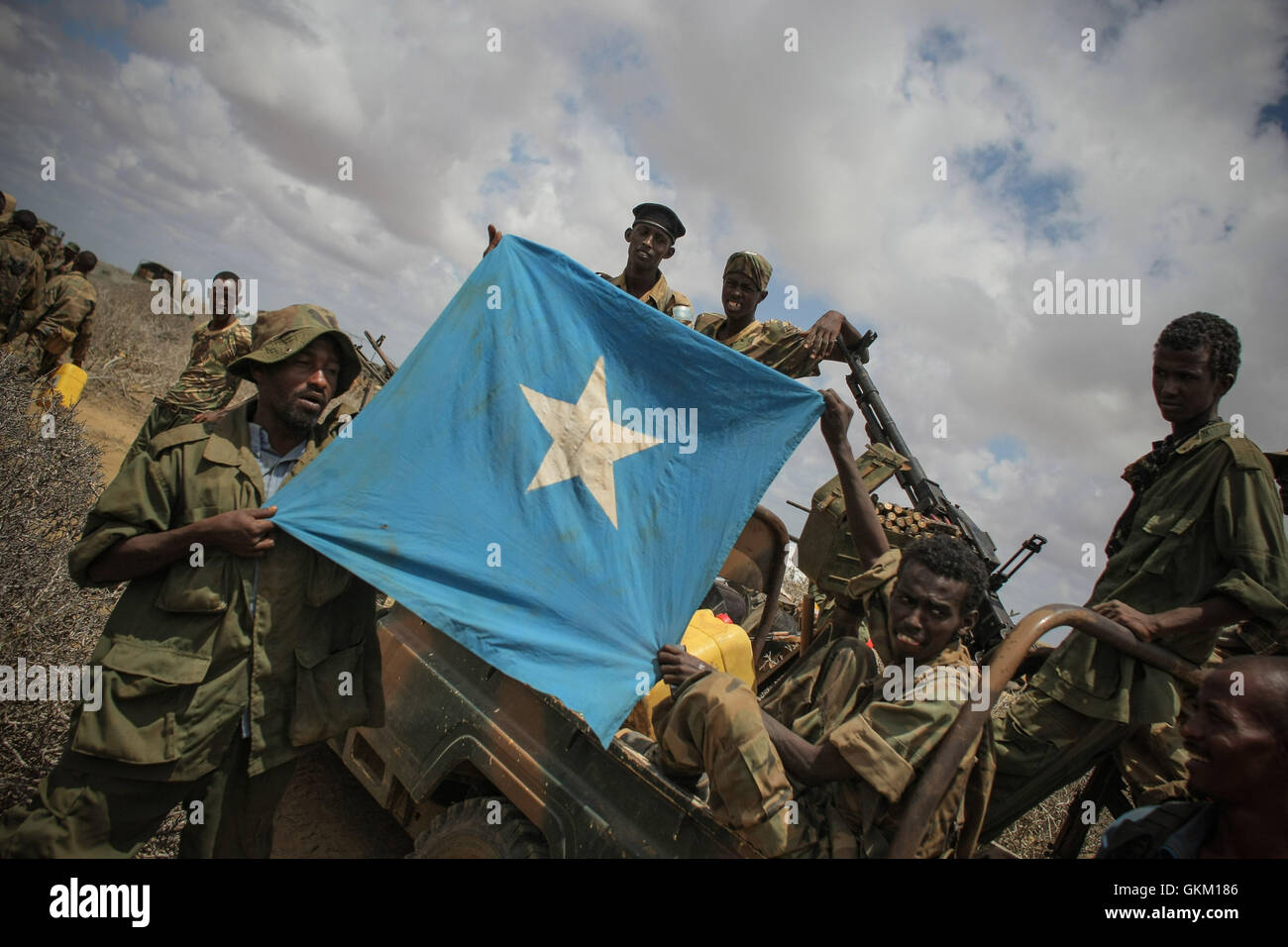 Soldiers of the Somali National Army (SNA) raise the Somali national ...