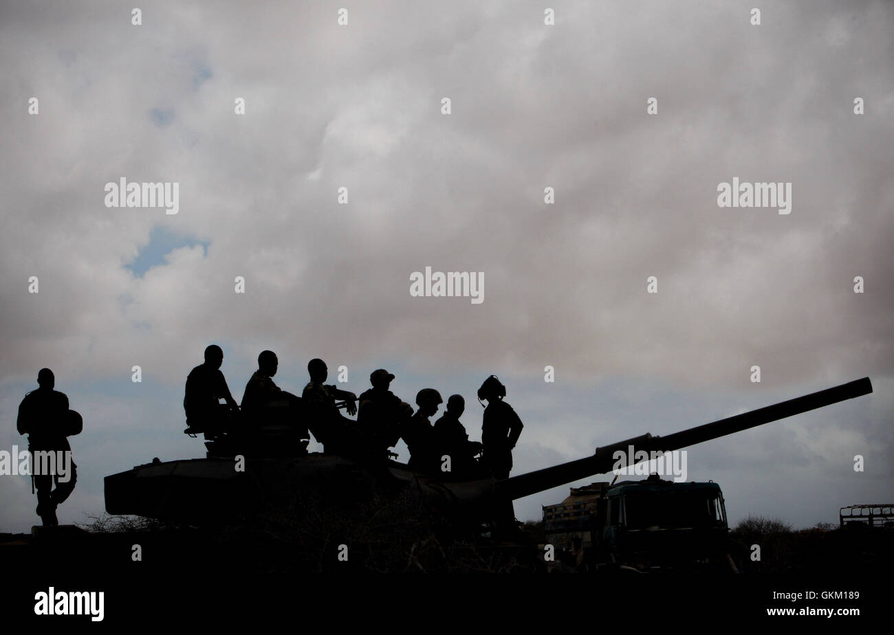 Kenyan soldiers serving with AMISOM stand atop a tank in Saa'moja, 7 km ...