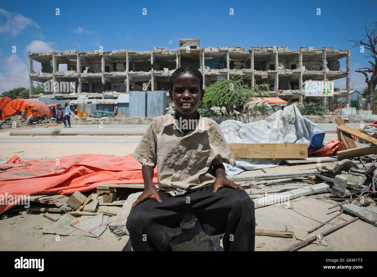 A Somali boy sits on building materials in the Abdul-Aziz district of ...