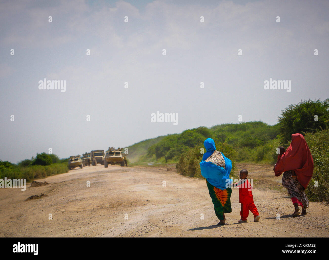 Somali women and children walk along a road in Middle Shabelle on ...
