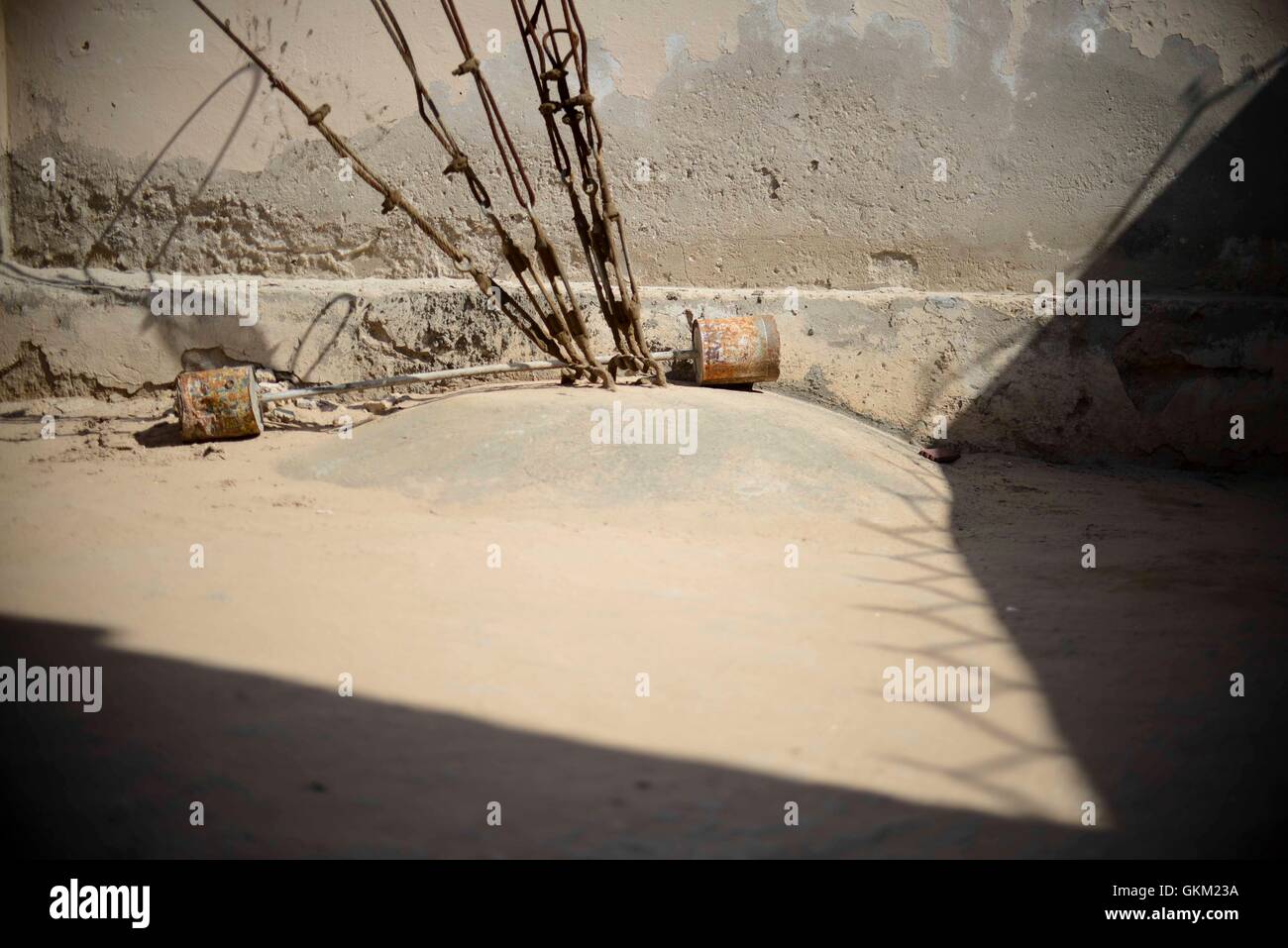 A homemade weight made out of concrete and two old paint cans sits at ...