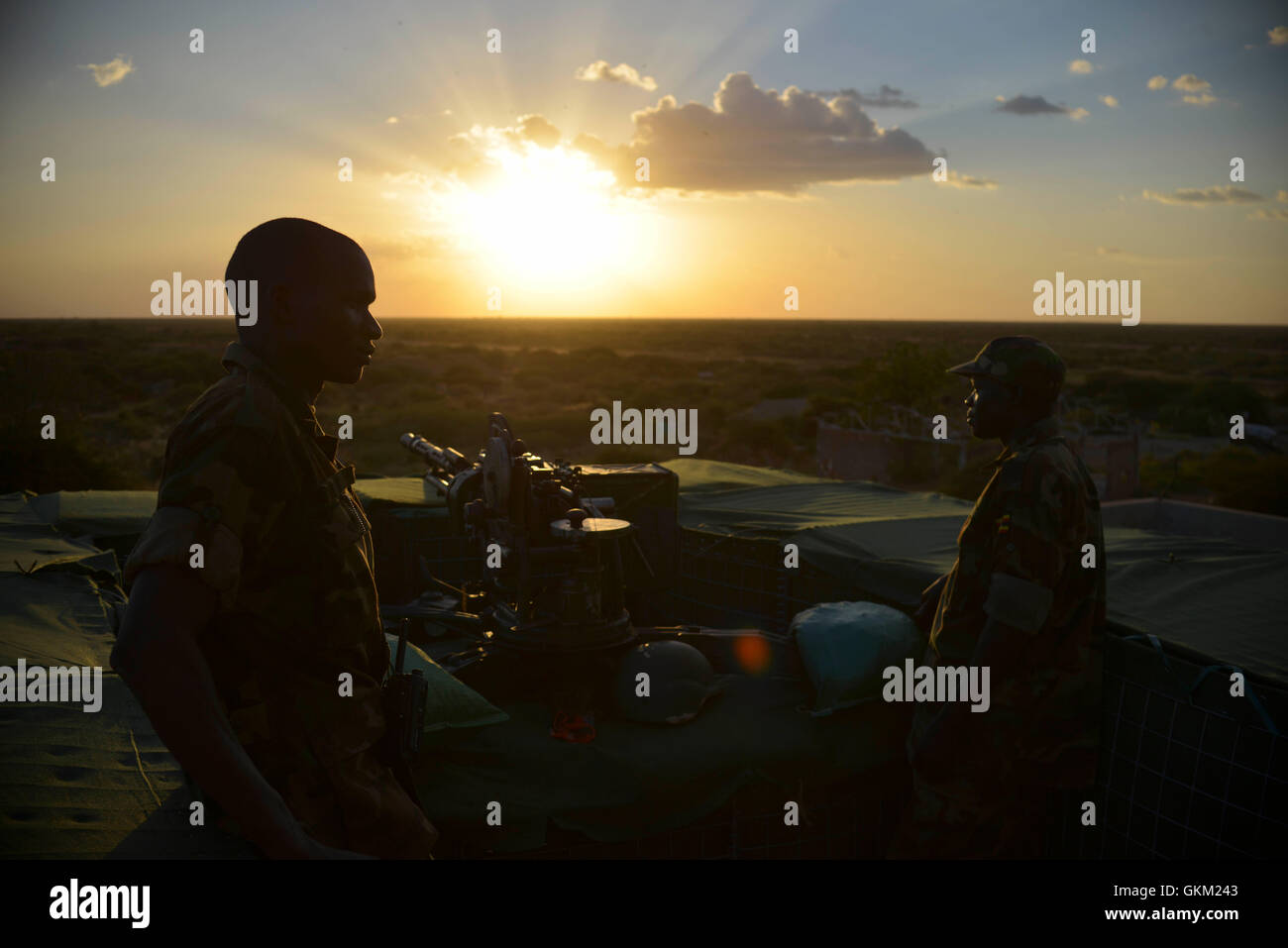 Two soldiers keep watch as the sun sets over Ballidoogole Airbase in ...