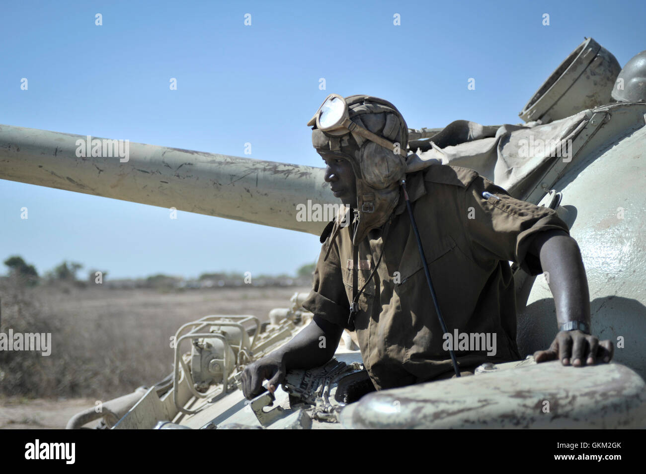 A Ugandan tank driver steps out of his vehicle during a convoy stop on ...