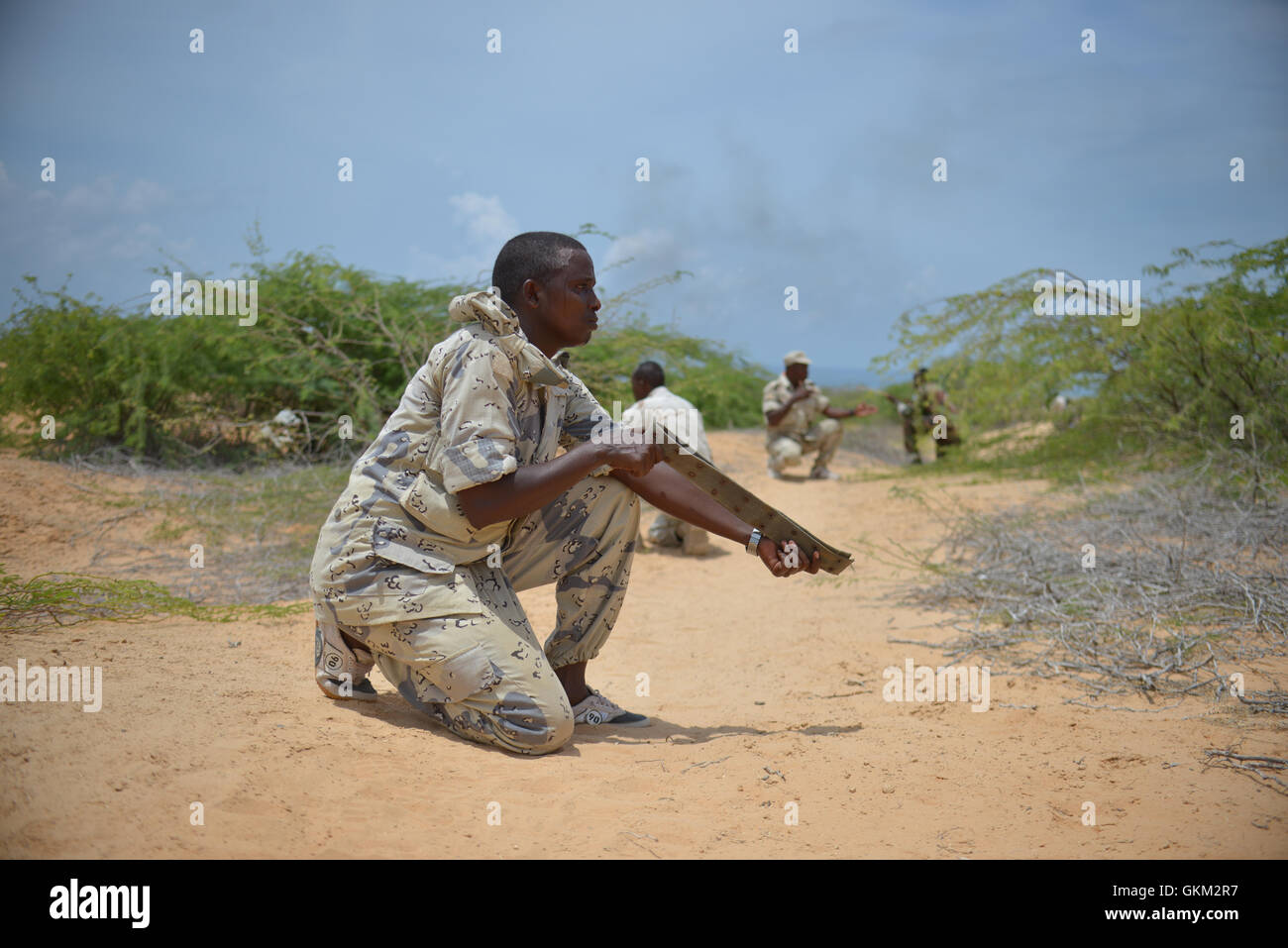 A Somali National Army soldier uses a belt as a simulated weapon during ...
