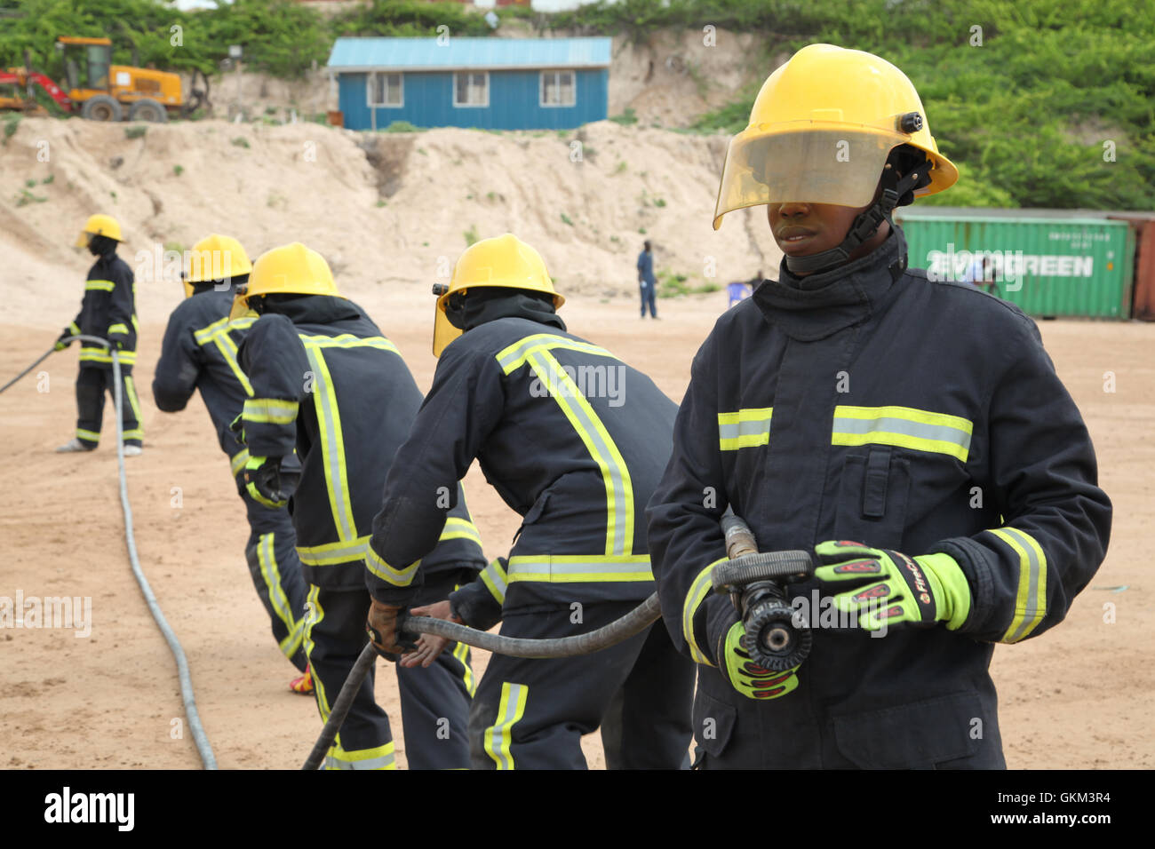 Somali firemen showcase their newly acquired firefighting skills in an ...