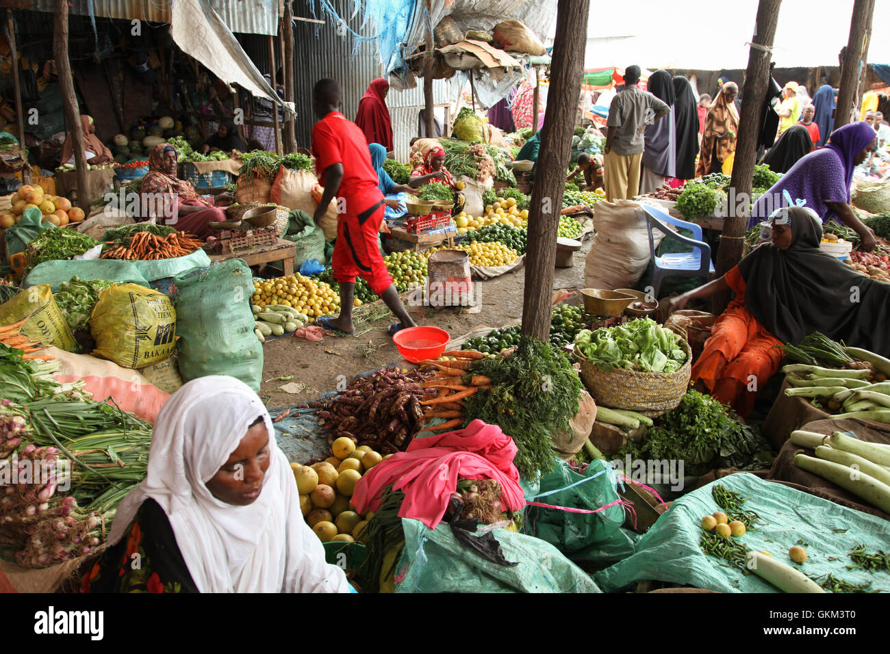 Women in a Mogadishu marketplace prepare produce for sale on July 11 ...