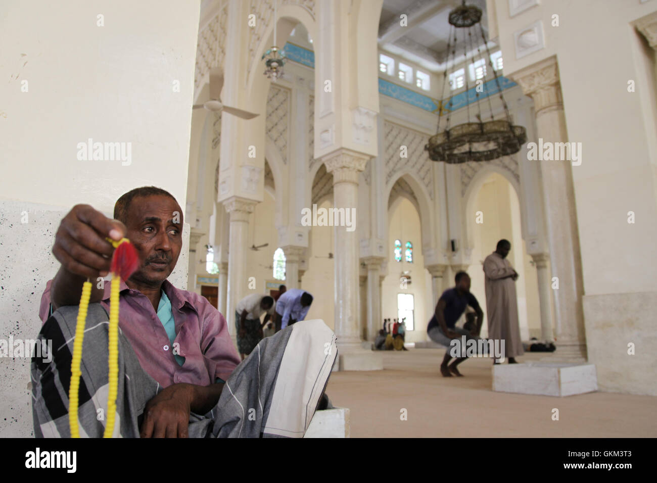 During the holy month of Ramadan, a man holds prayer beads at a mosque ...