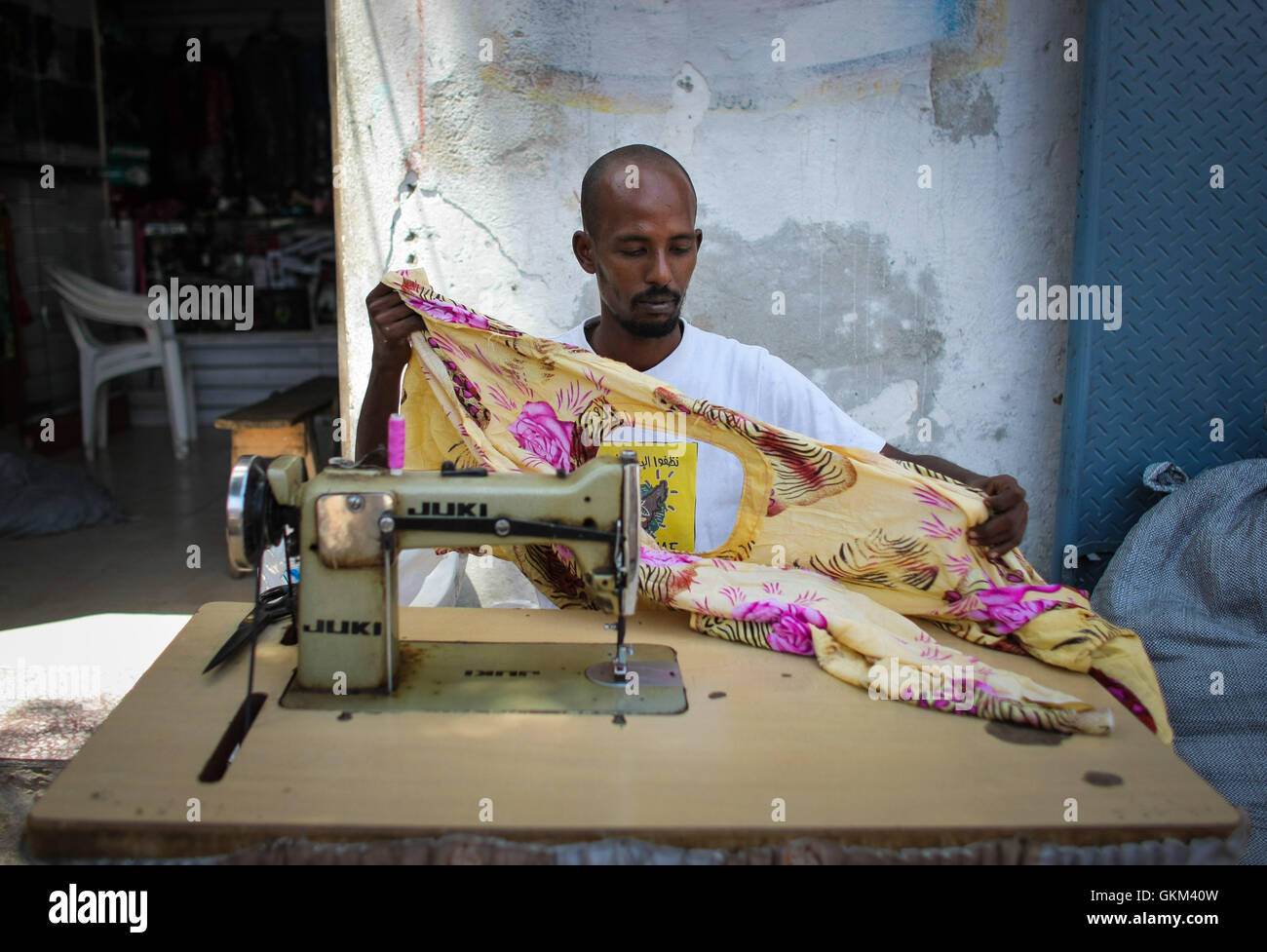 A tailor works outside his shop in Hamar Weyne market, Mogadishu, on ...