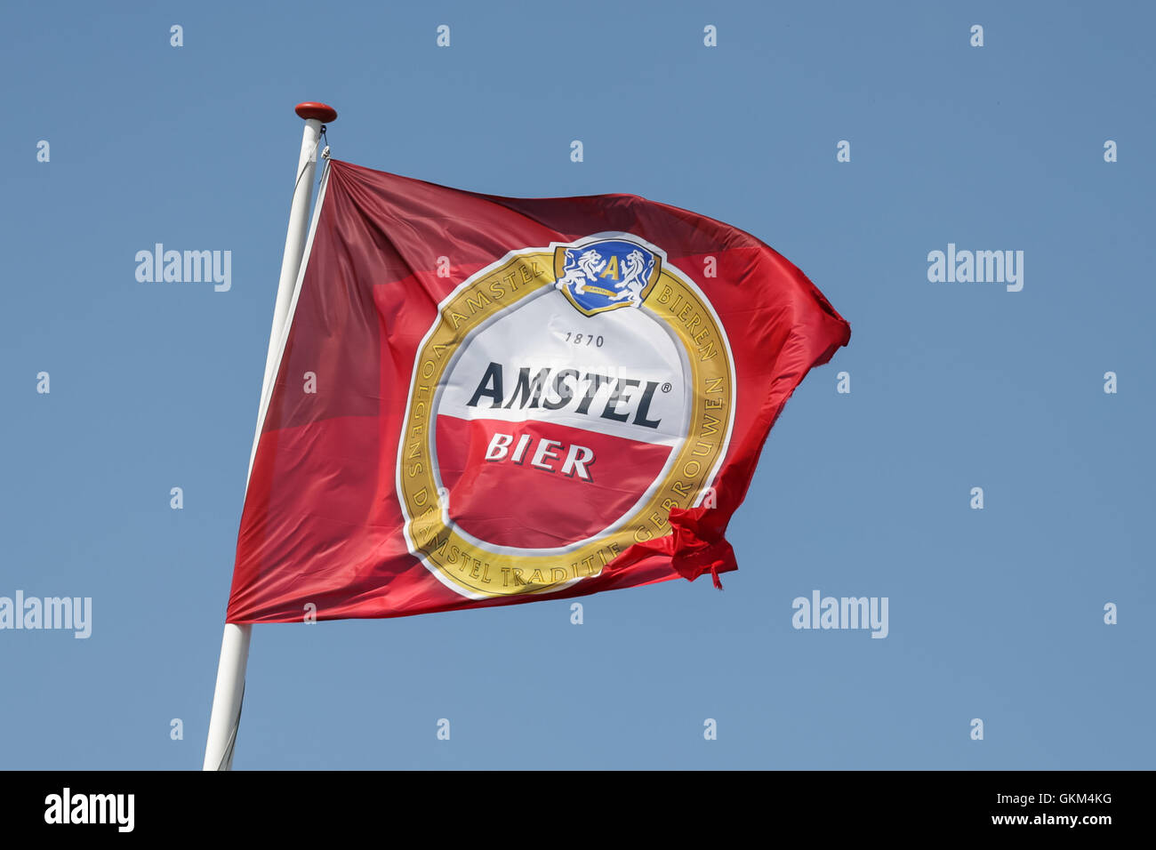 Flying Amstel Beer flag against a blue sky, Amstel bieren volgens ...