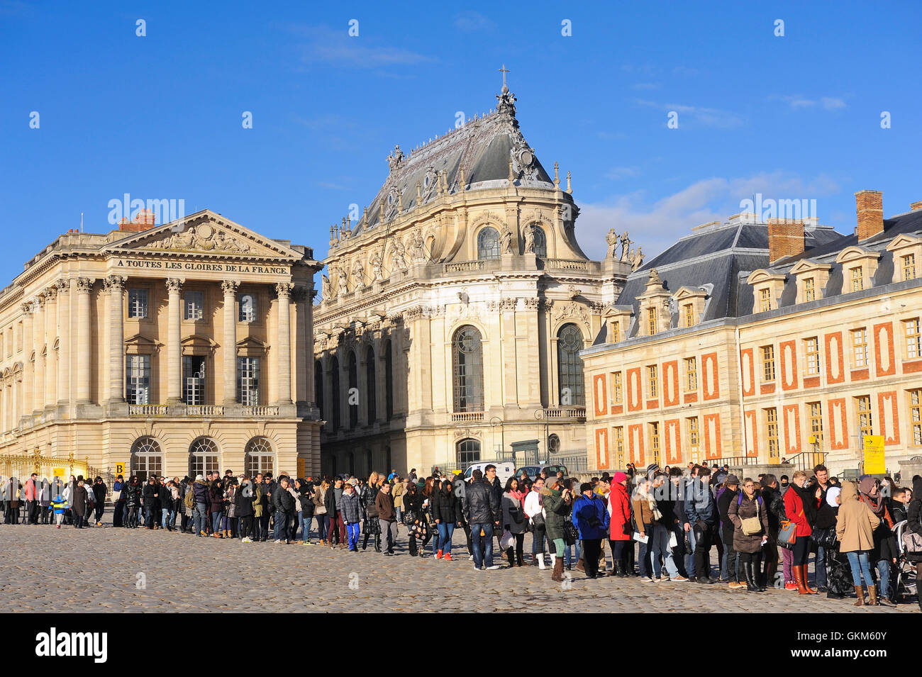 The castle of Versailles and the crowd of foreign tourists forming an ...