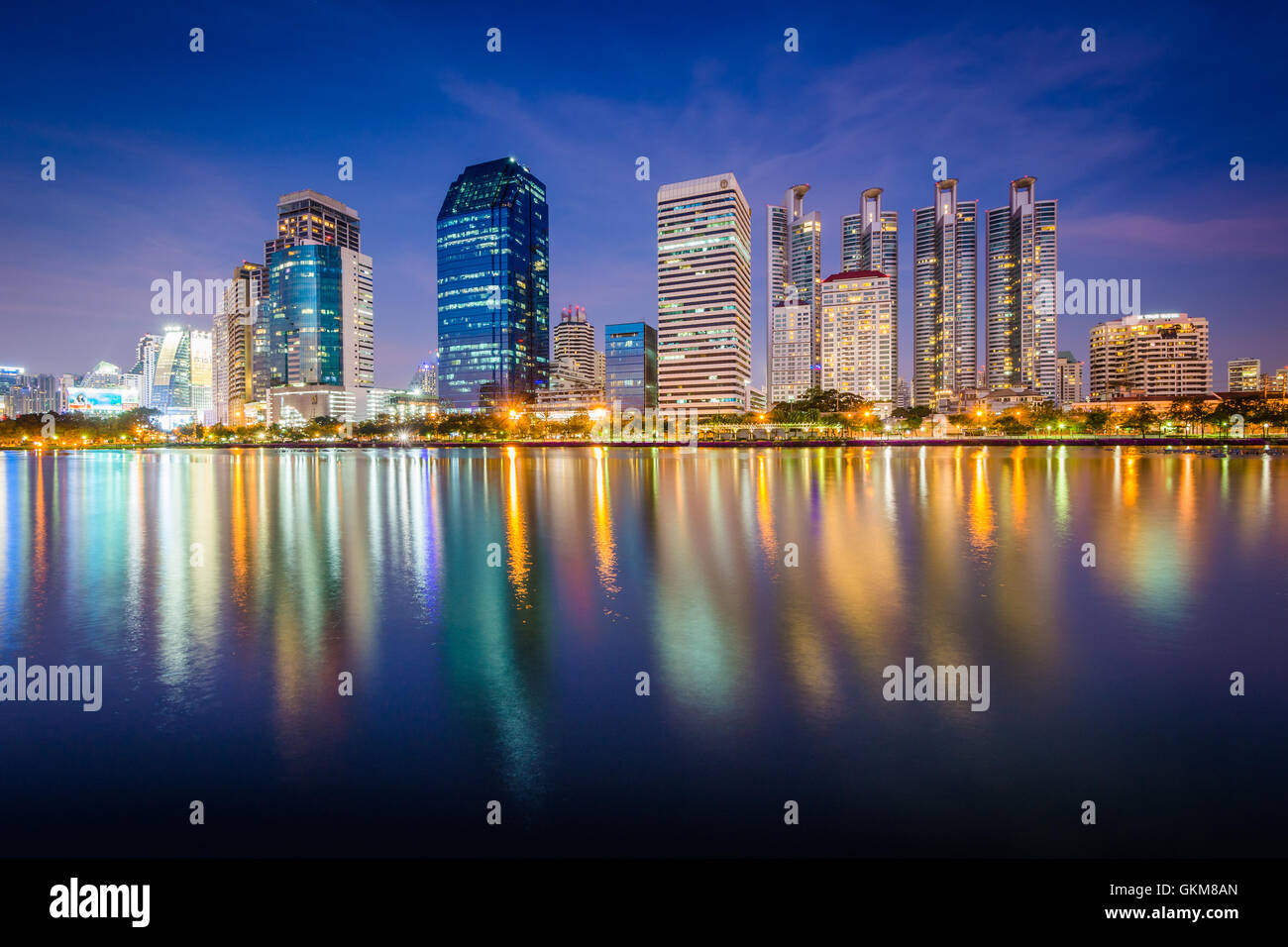 Modern skyscrapers and Lake Rajada at night, at Benjakiti Park, in ...