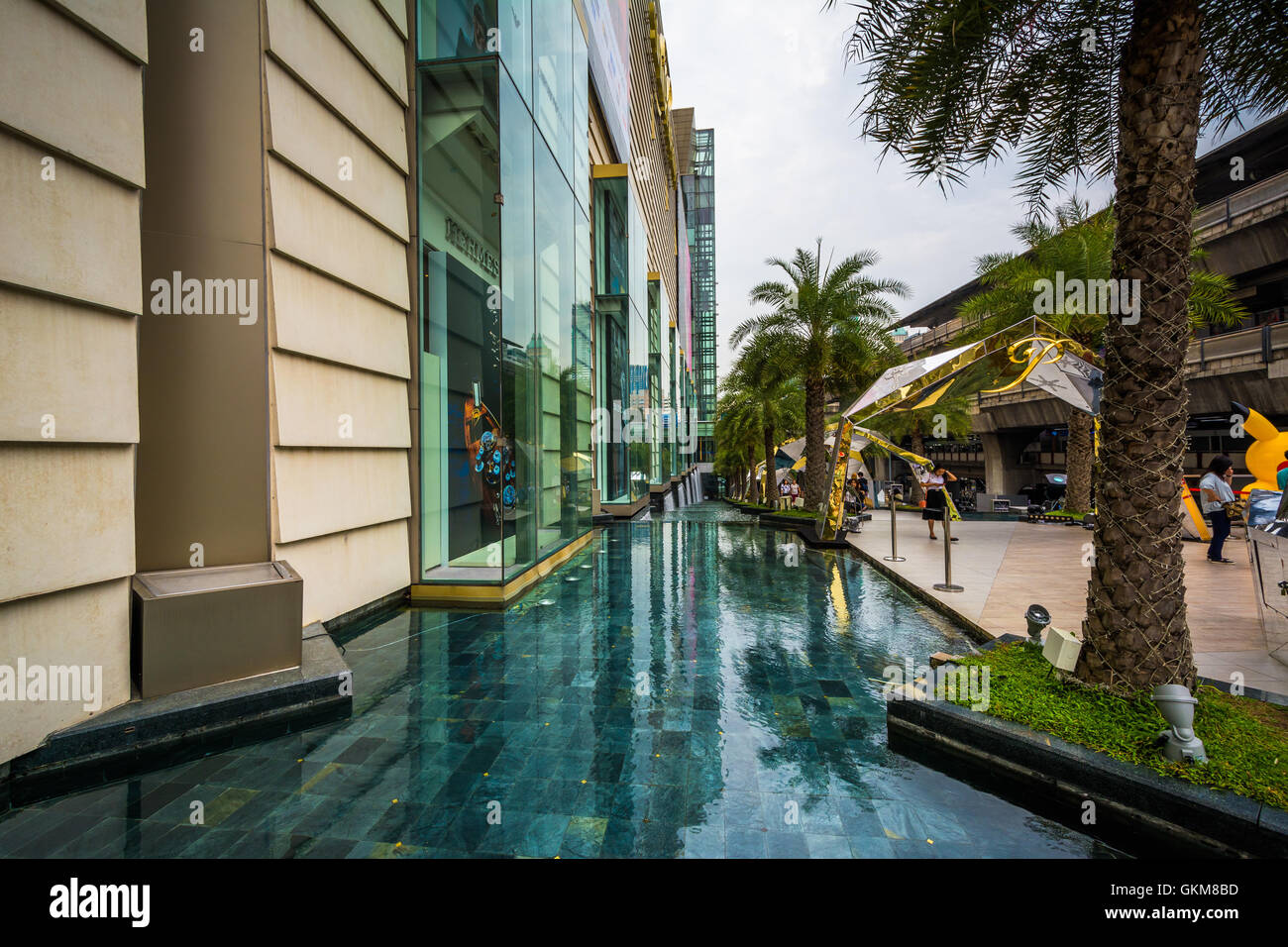 Pool and palm trees outside a mall in the Siam District, Bangkok ...
