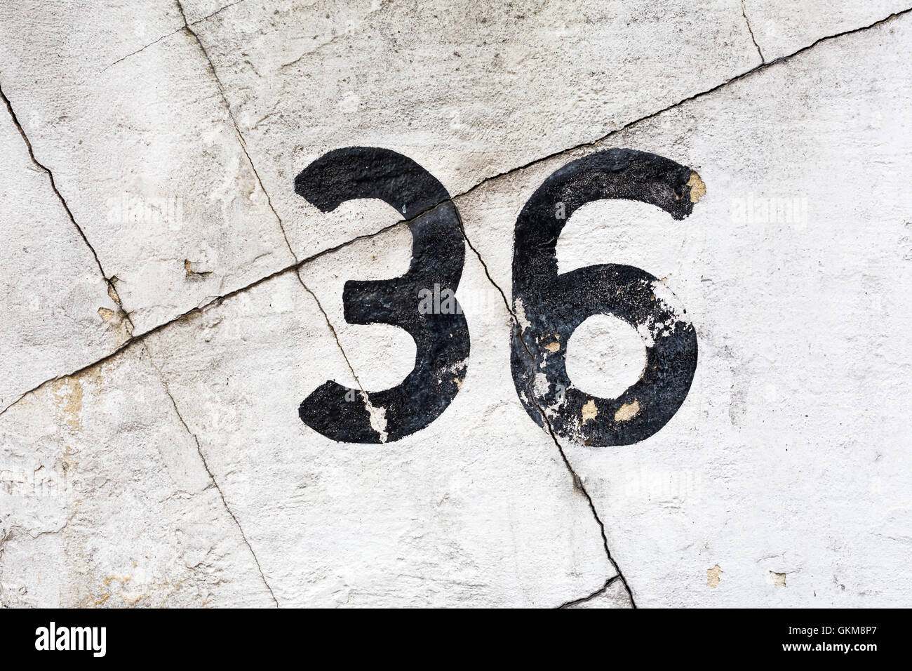 number 36 painted on a cracked house wall Stock Photo - Alamy