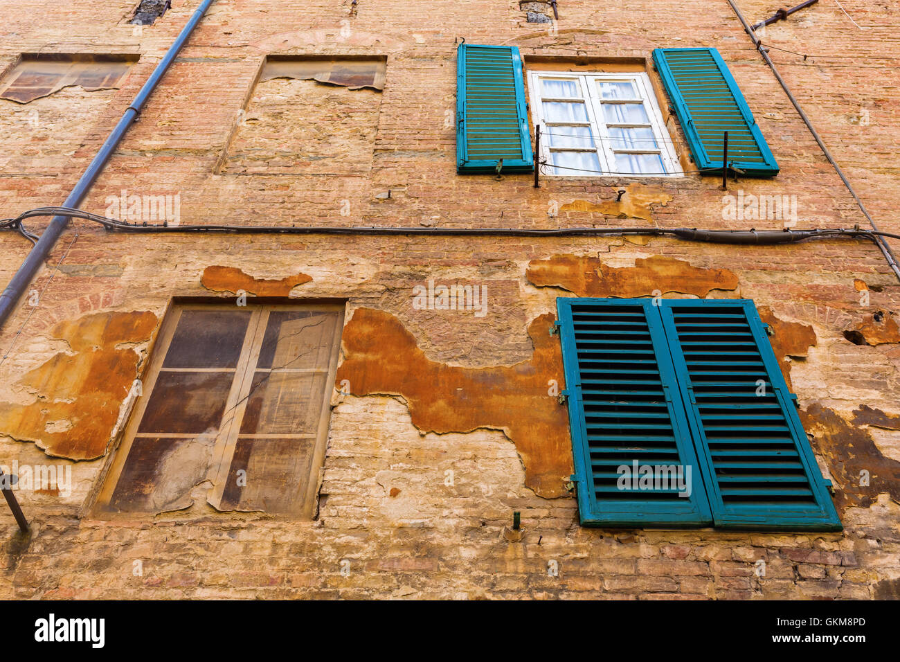 unique windows at an old house in Siena, Italy Stock Photo - Alamy
