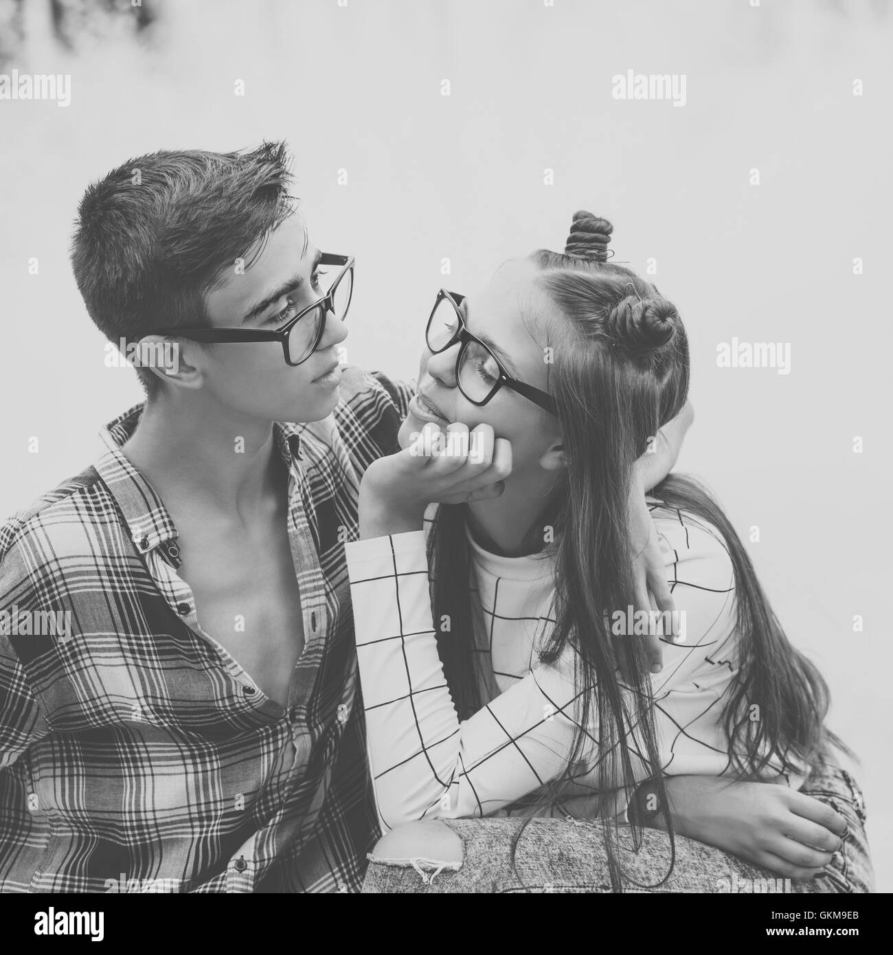 Loving couple teenagers. Girlfriend and boyfriend hugging. They wear ...