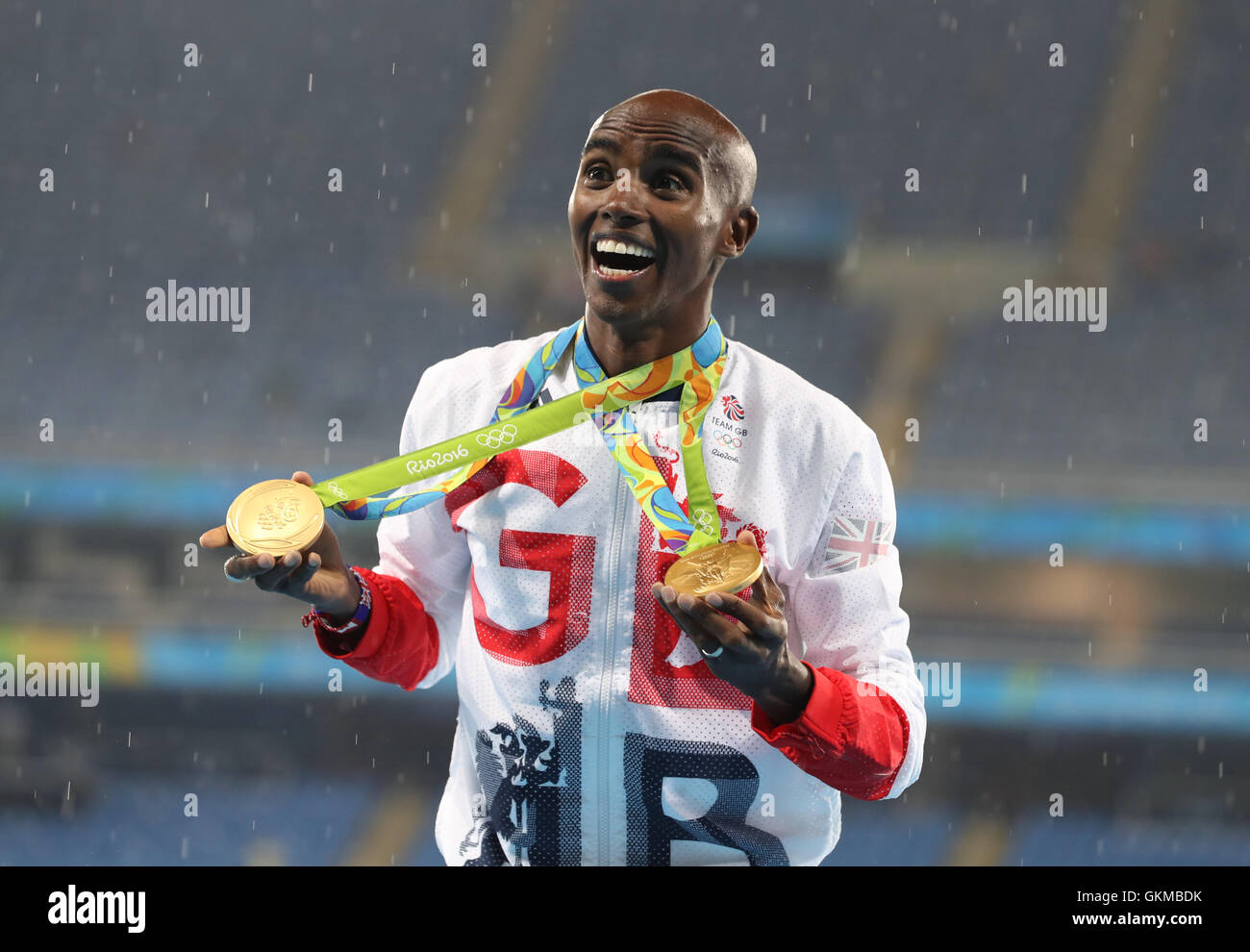 Great Britain's Mo Farah celebrates with his gold medals after winning ...