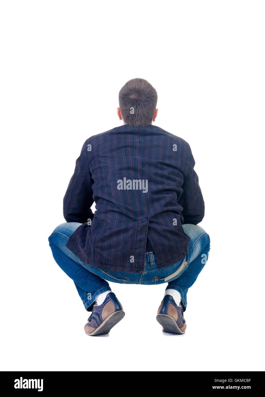 Sitting young man looking afar. Rear view Stock Photo - Alamy