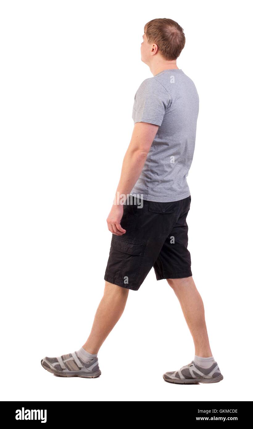 Back view of walking handsome man in shorts and sneakers Stock Photo ...