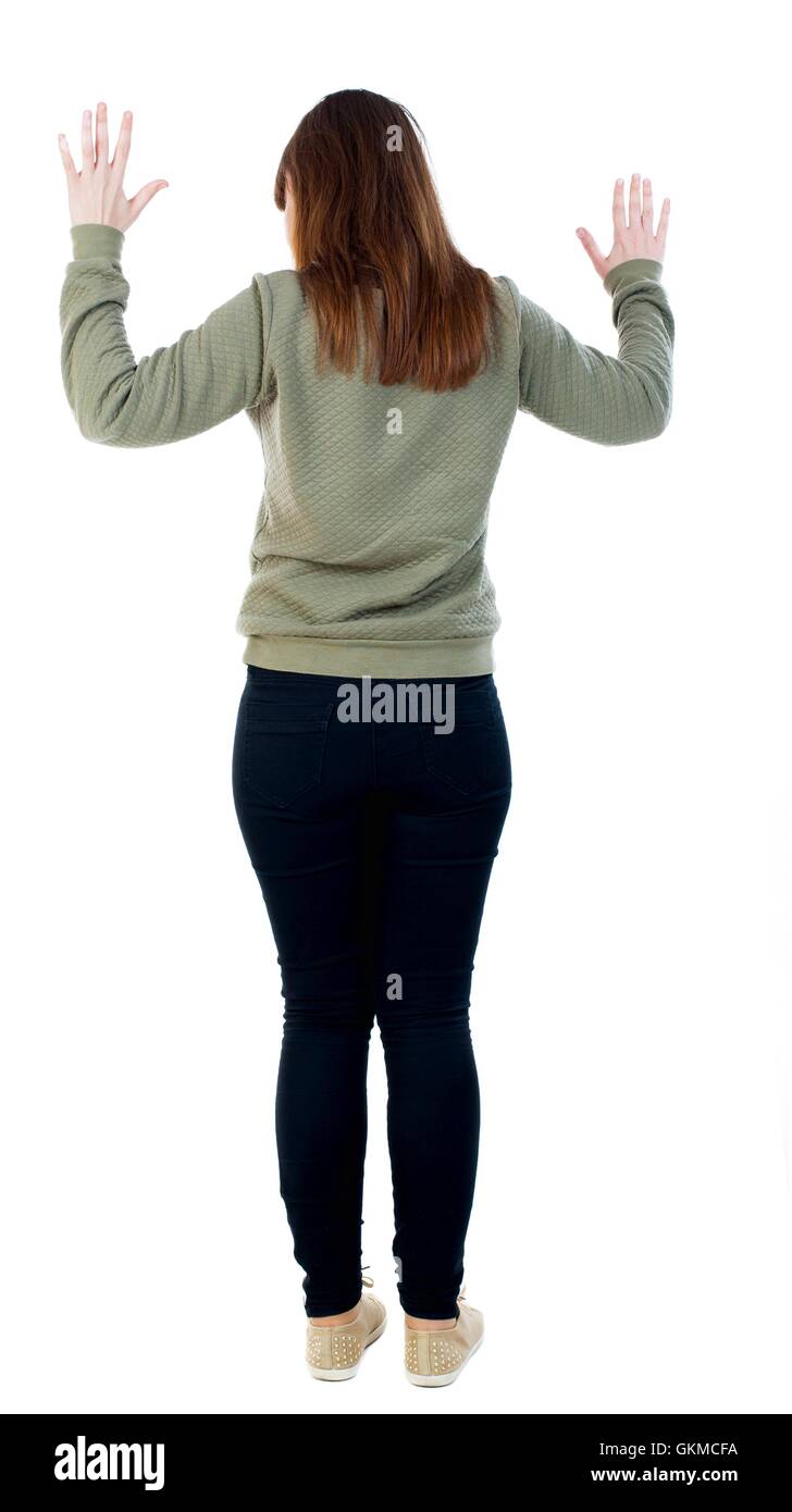 back view of woman protects hands from what is falling from abo Stock ...