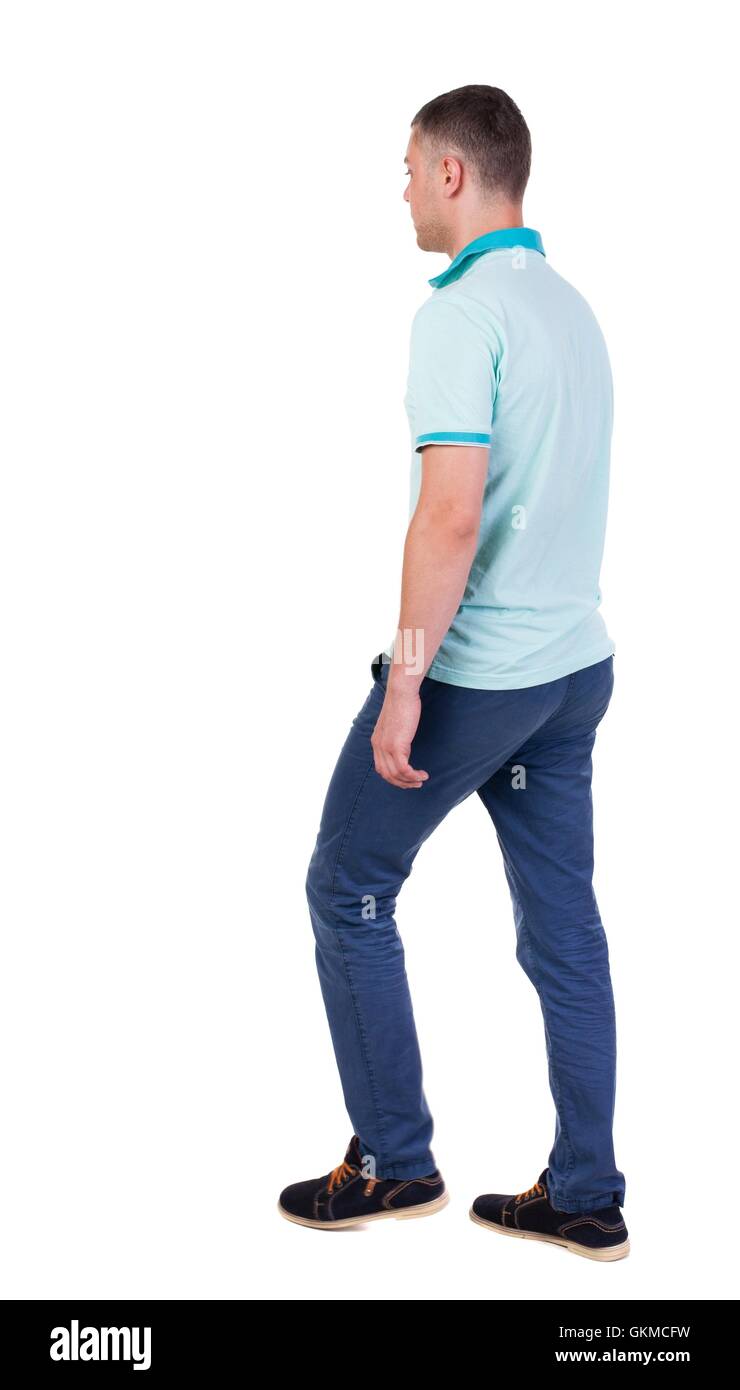 Back view of going handsome man in jeans and a shirt Stock Photo - Alamy