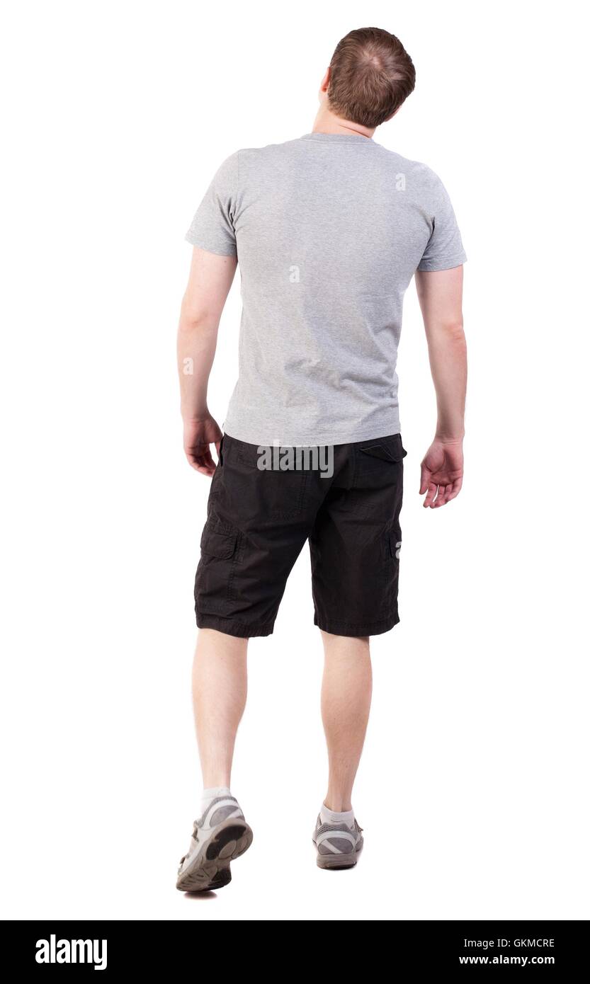 Back view of walking handsome man in shorts and sneakers Stock Photo ...