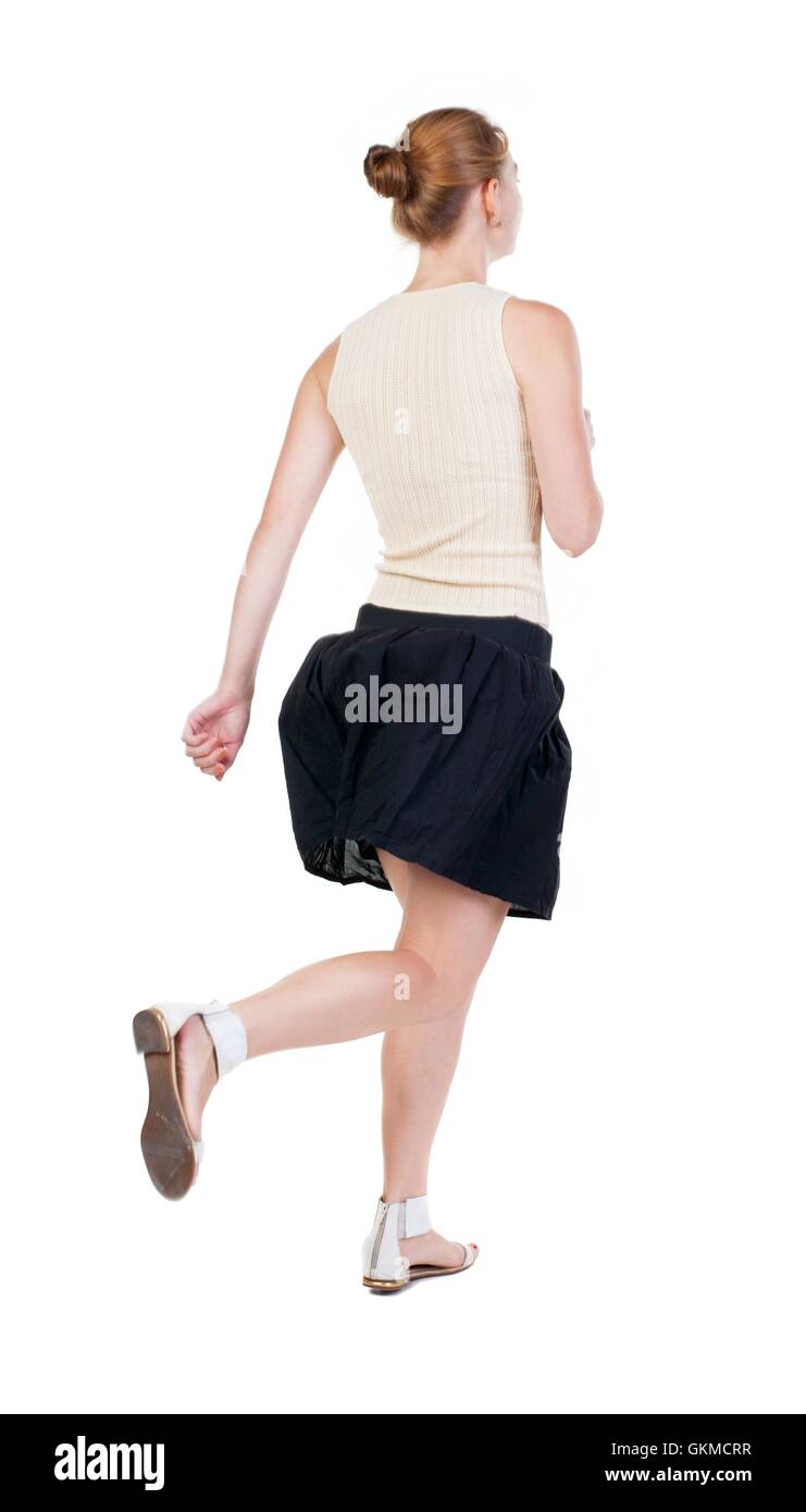 back view of running woman in dress Stock Photo - Alamy