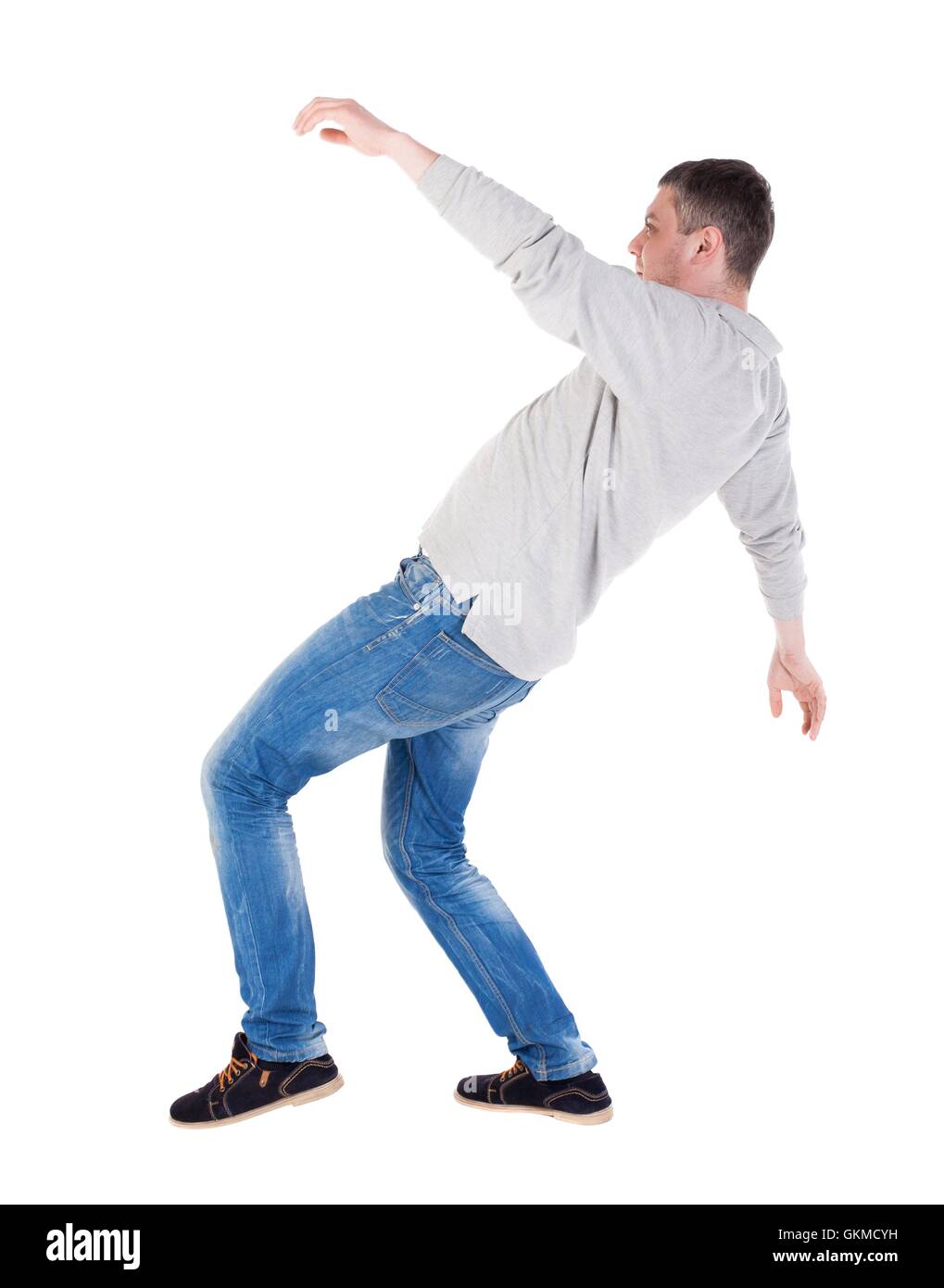 Back view man Balances waving his arms Stock Photo - Alamy