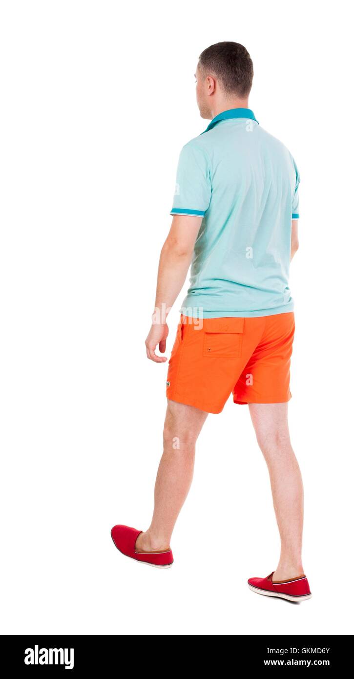 Back view of going handsome man in shorts. walking young guy Stock ...