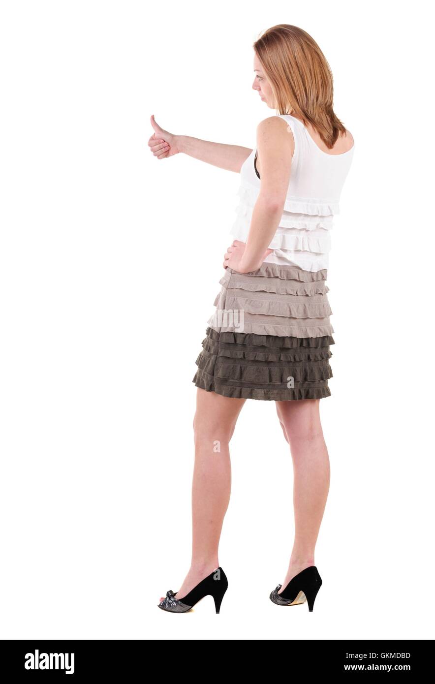 Beautiful young woman looking at wall Stock Photo - Alamy
