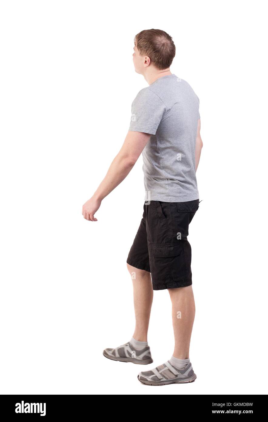 Back view of walking handsome man in shorts and sneakers Stock Photo ...
