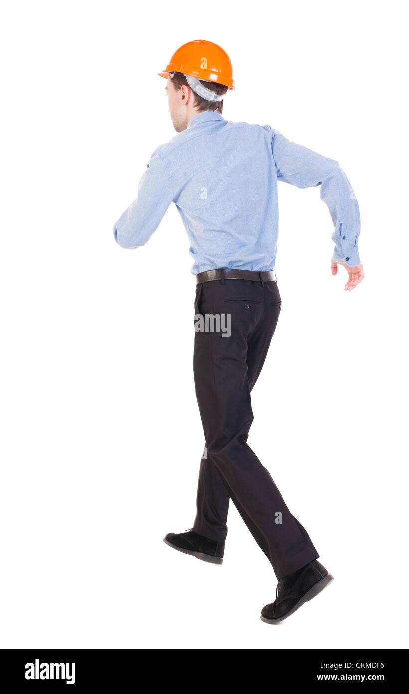 Back view of running engineer in helmet. Walking guy in motion Stock ...