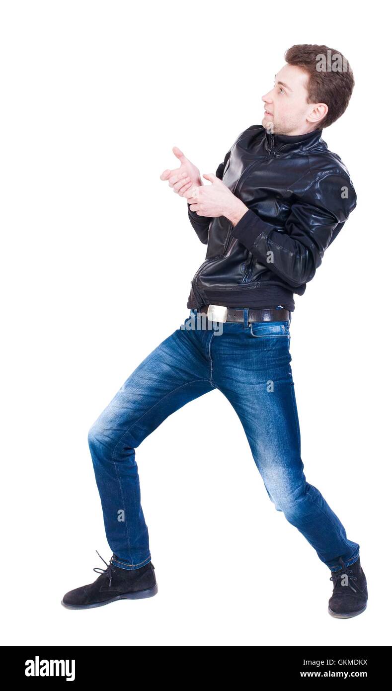 back view of standing man pulling a rope from the top or cling t Stock ...