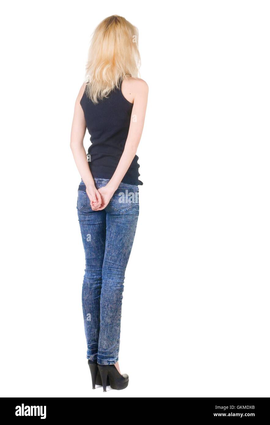 Beautiful young woman looking at wall Stock Photo - Alamy