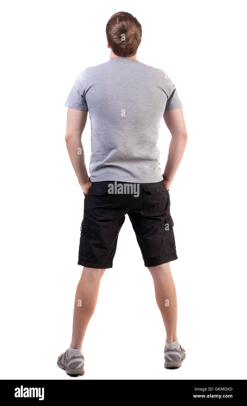 Back view of handsome man in t-shirt and shorts looking up Stock Photo ...